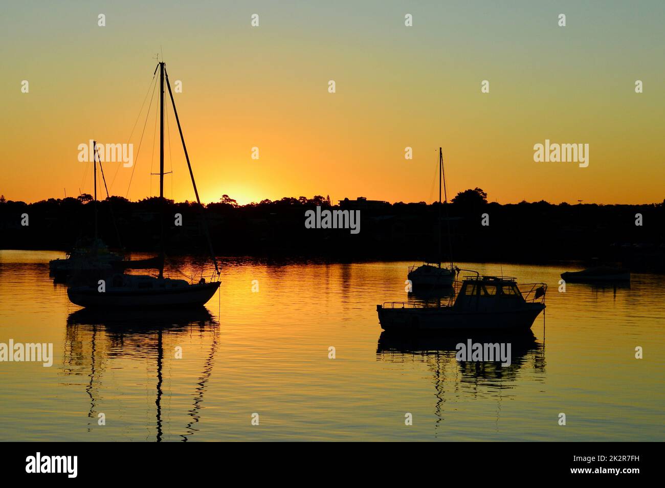 Boats on the harbor at sunset Stock Photo - Alamy