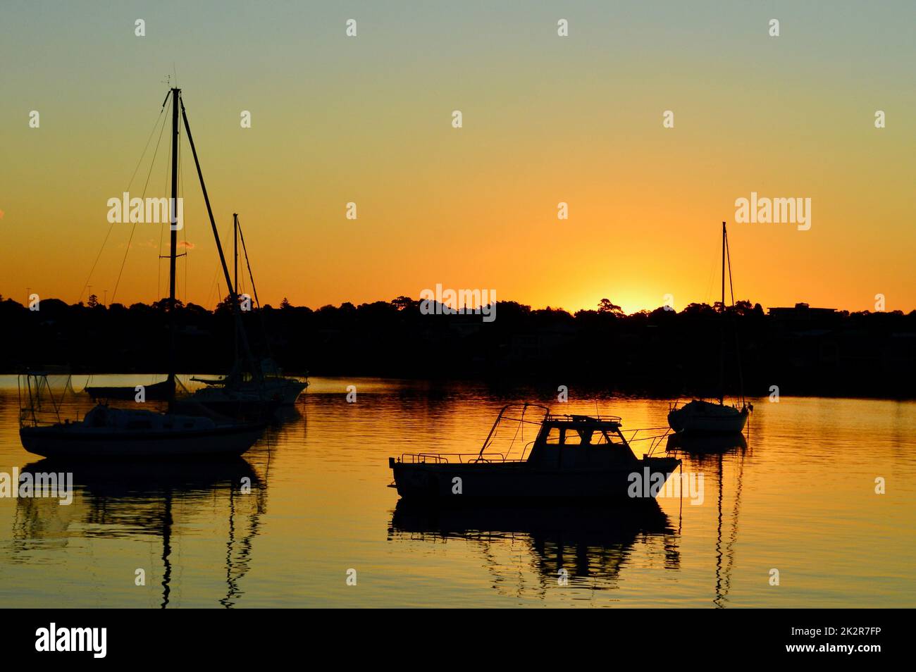 Boats on the harbor at sunset Stock Photo - Alamy