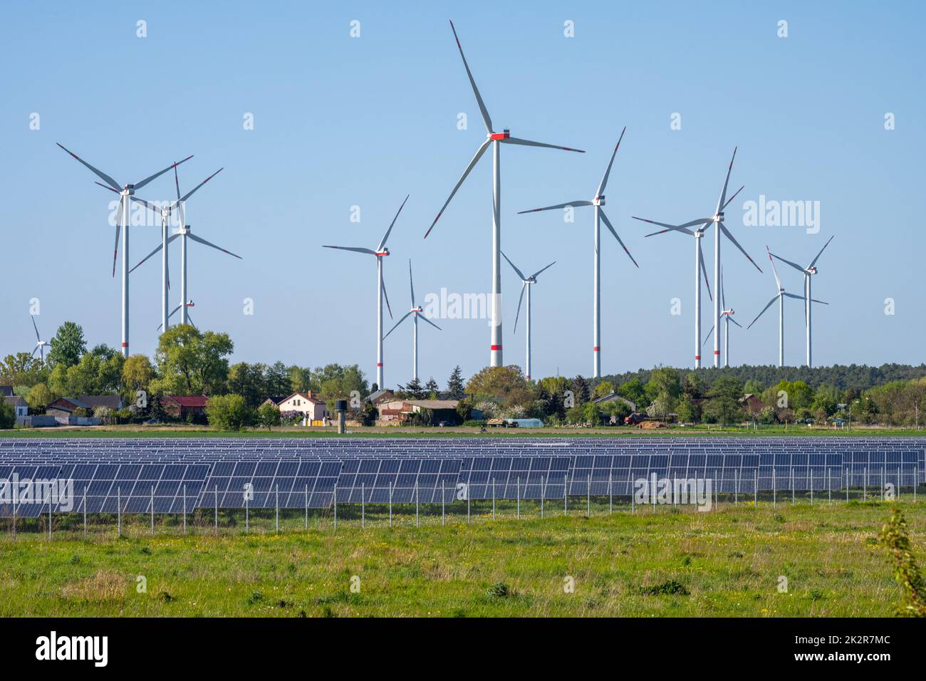 Solar panels with wind wheels in the back seen in Germany Stock Photo ...