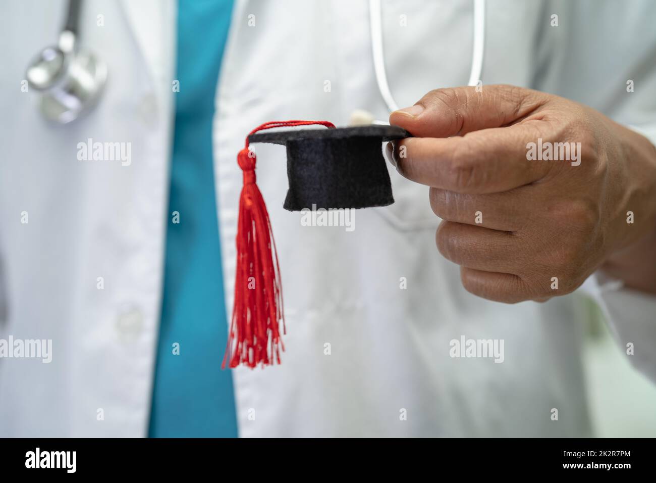 Asian doctor study learn with graduation gap hat in hospital ward ...