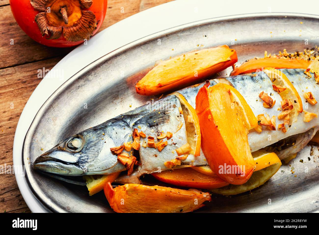 Baked scomber fish with persimmon Stock Photo - Alamy