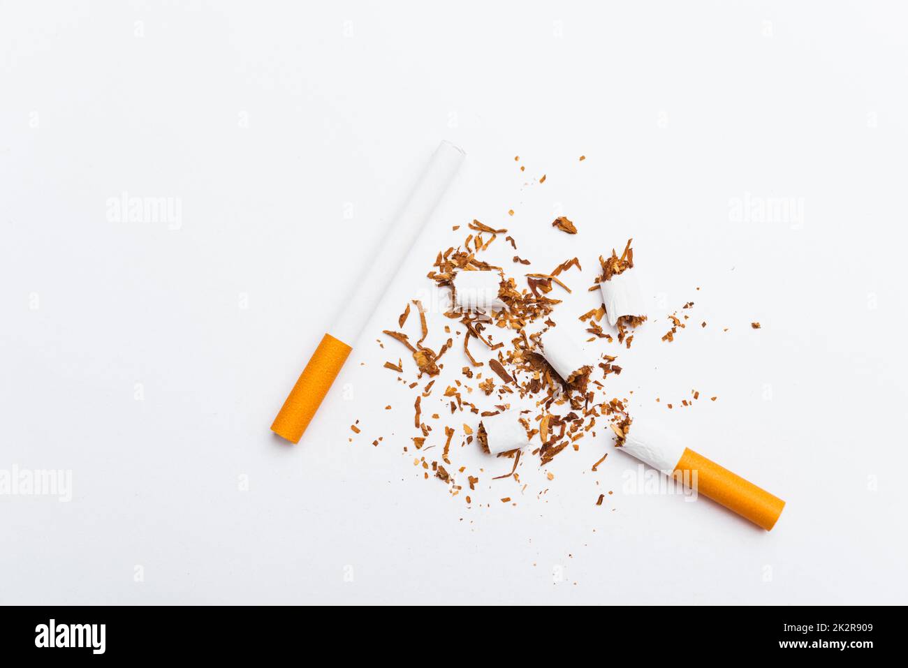 broken pile cigarette or tobacco on white background Stock Photo - Alamy