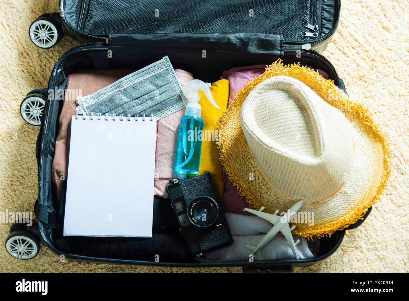 Open suitcase with traveler belongings clothes and accessories of ...