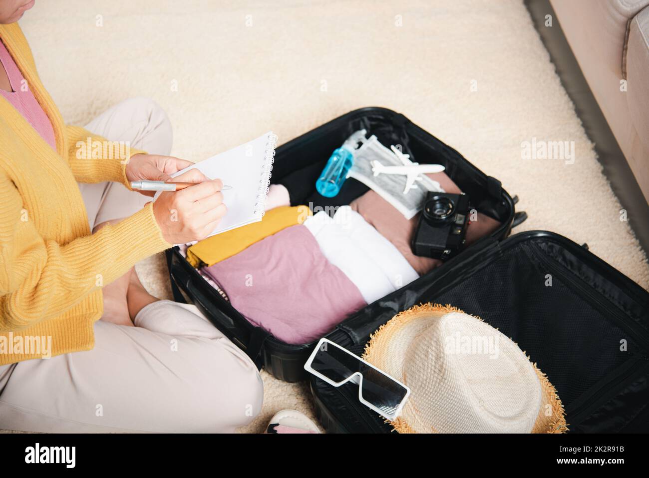 Woman writing paper take note and packing suitcase to vacation writing ...