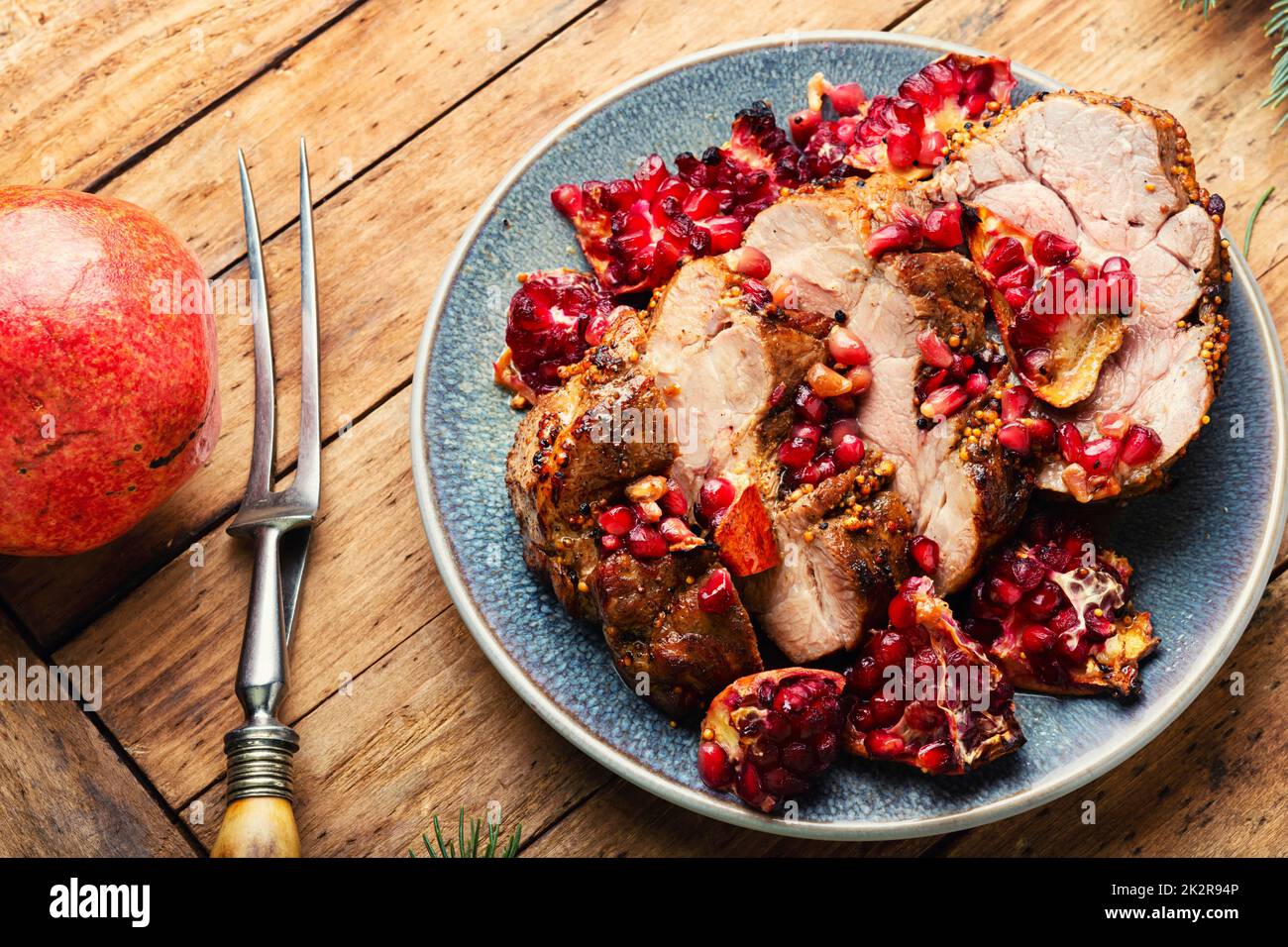 Pork roast in pomegranate marinade Stock Photo - Alamy