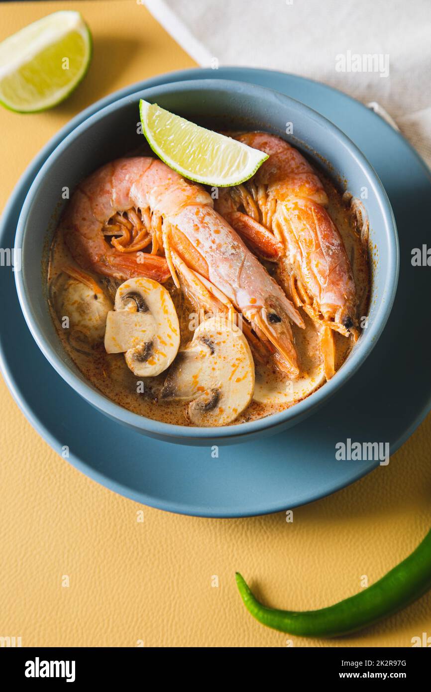 Tom Yum Goong Spicy Sour Soup on trendy table top view, Thai local food ...