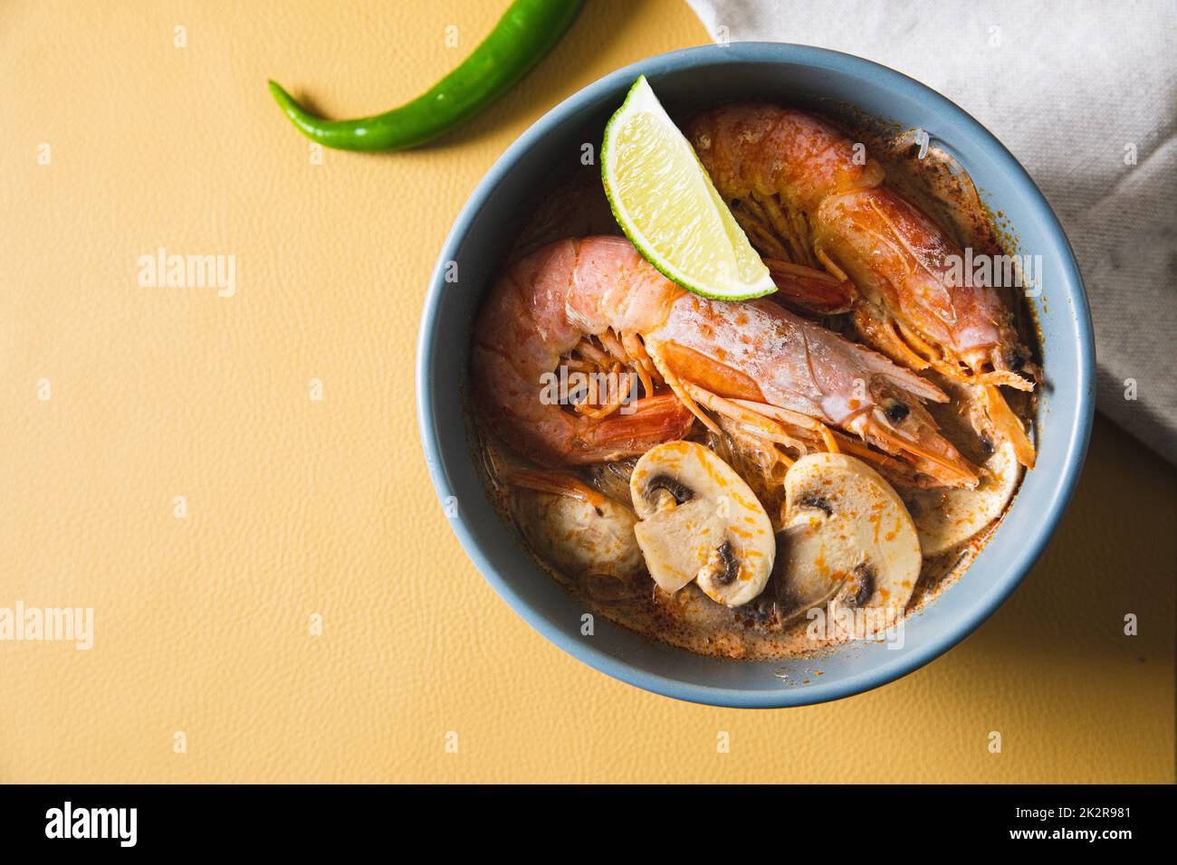 Tom Yum Goong Spicy Sour Soup on trendy table top view, Thai local food ...