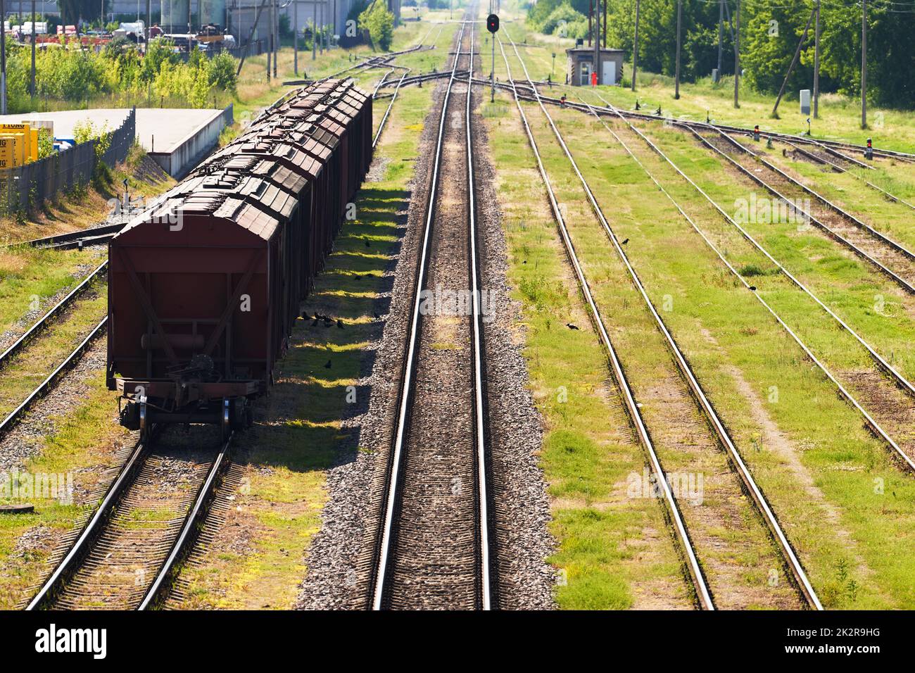 A train on an abandoned railroad track where grass has grown through ...