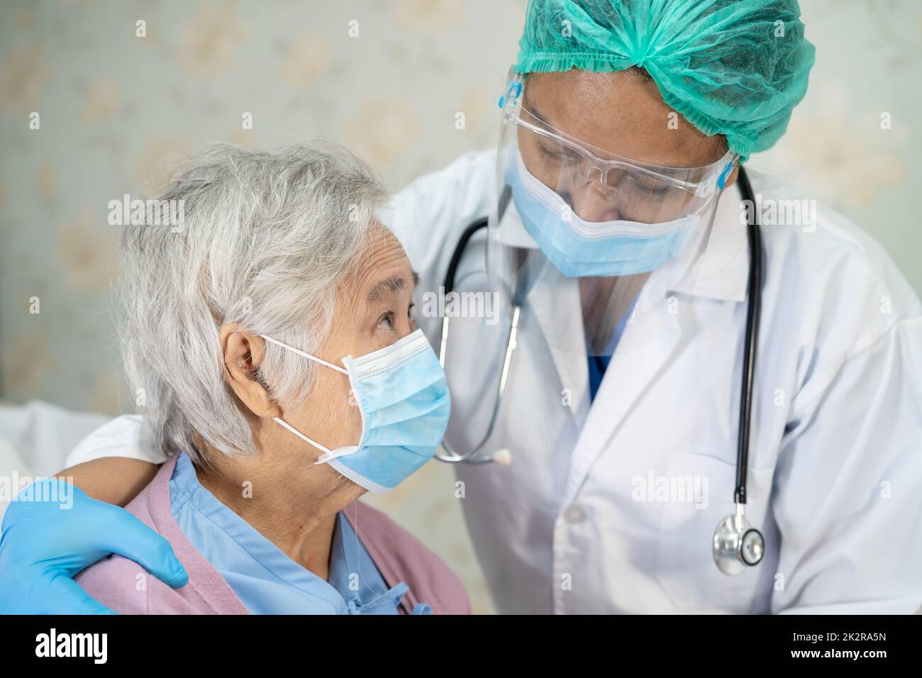 Doctor checking Asian senior or elderly old lady woman patient wearing ...