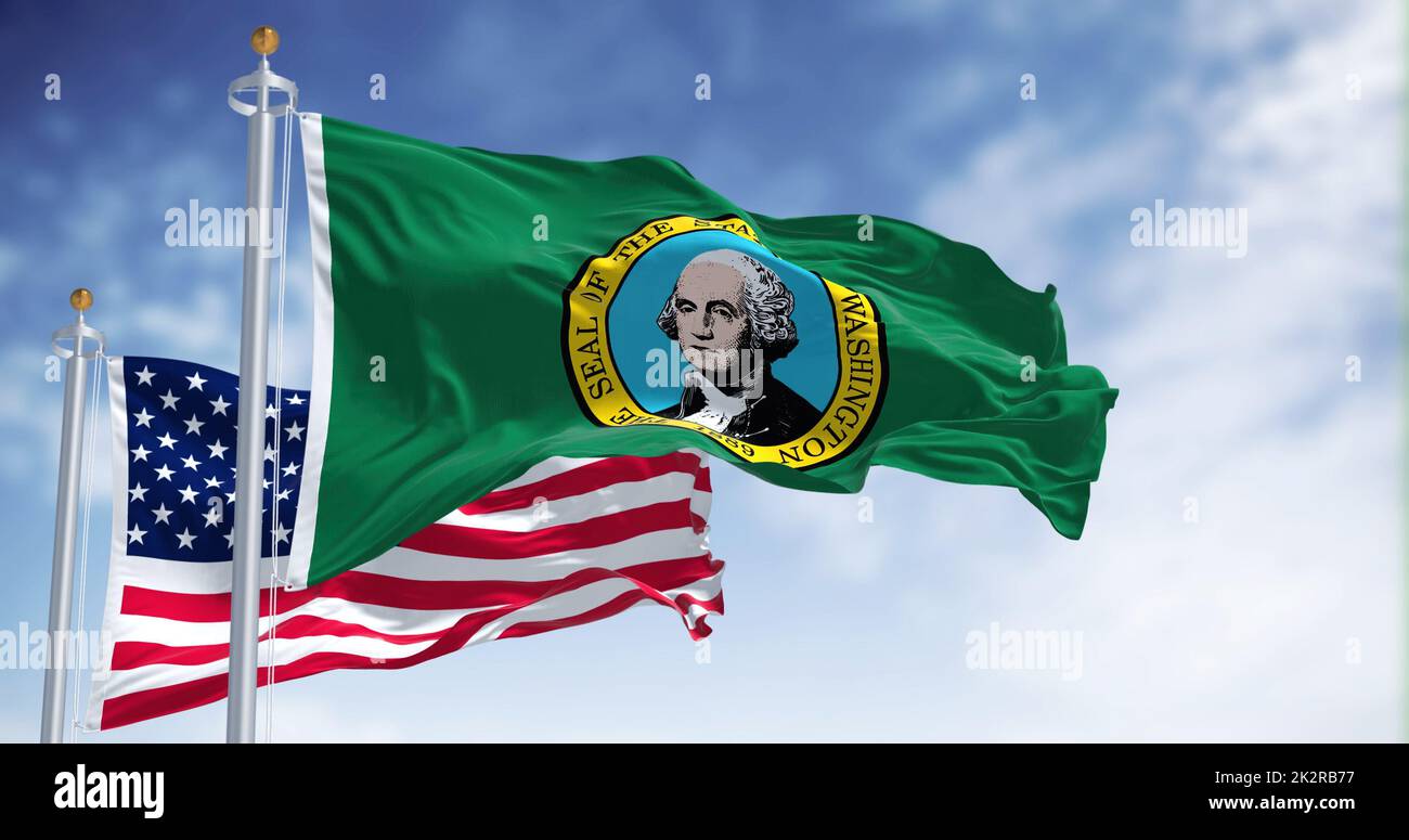 The Washington state flag waving along with the national flag of the ...