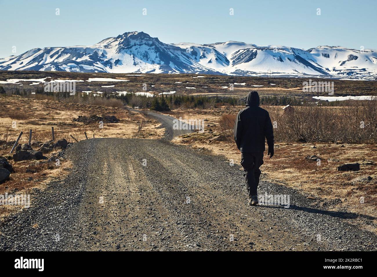 Man walking on gravel road in Iceland Stock Photo - Alamy