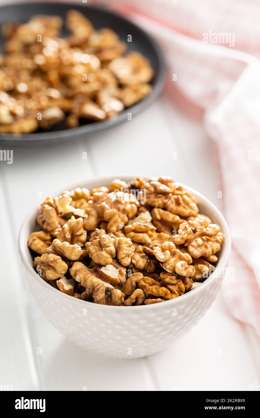 Peeled walnut kernels in bowl on white table Stock Photo - Alamy