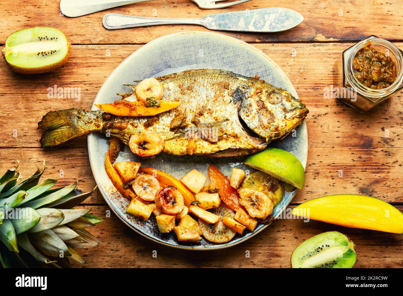 Baked fish with pineapple, mango and kiwi Stock Photo - Alamy