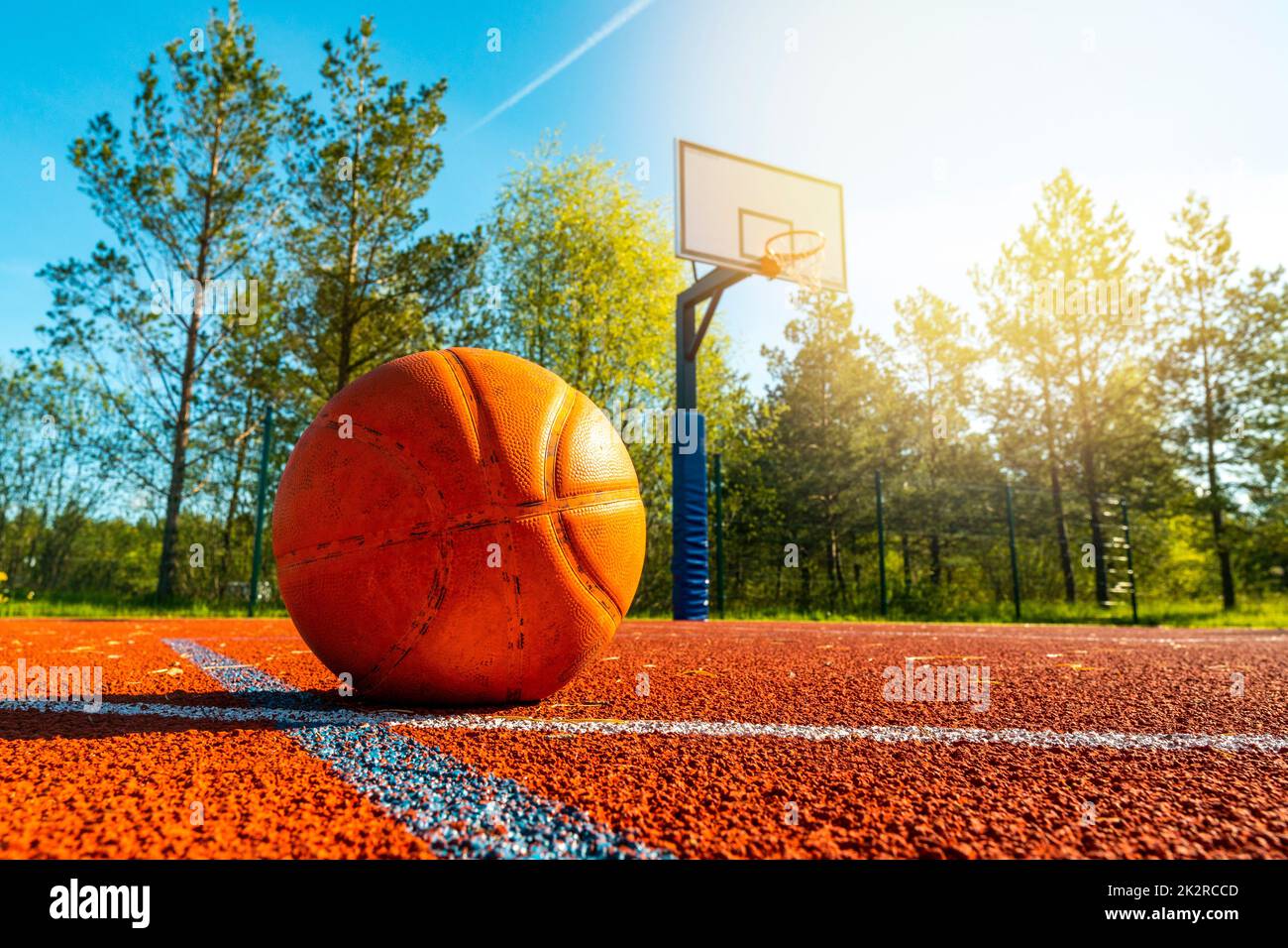Basketball ball on the outdoors court with hoop on the background Stock ...