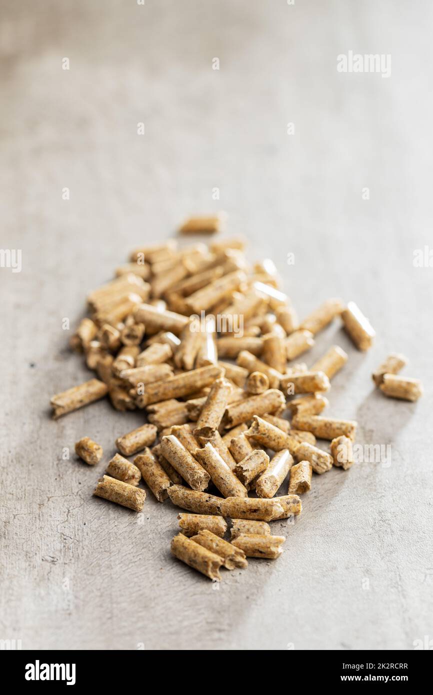 Wooden pellets, biofuel on wooden table. Ecologic fuel made from ...