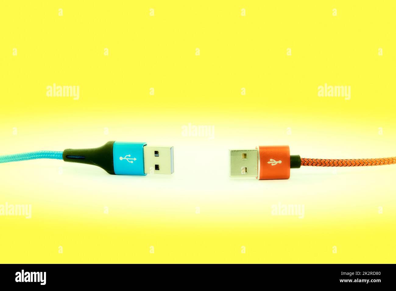 Blue red Universal Serial Bus cables isolated on yellow background ...