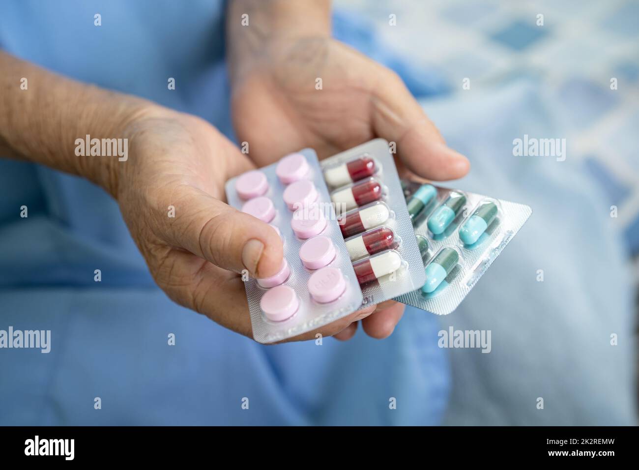 Asian senior or elderly old lady woman patient holding antibiotics ...