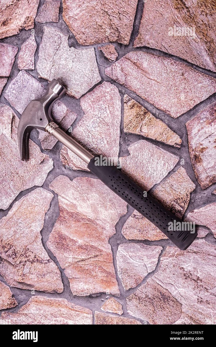 Hammer on stone background Stock Photo - Alamy