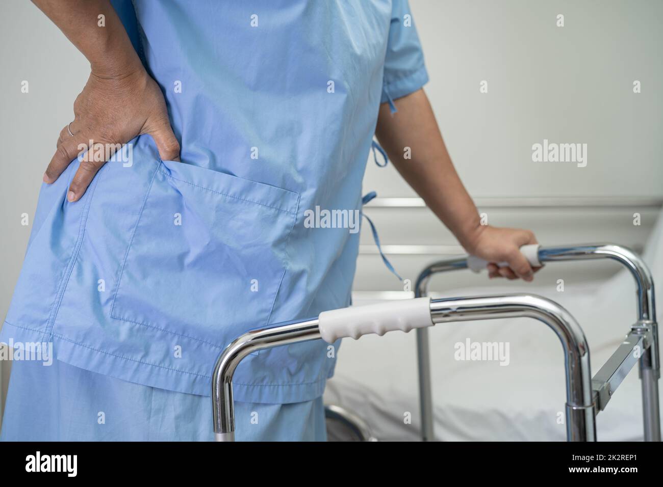 Asian lady woman patient walk with walker at nursing hospital ward ...