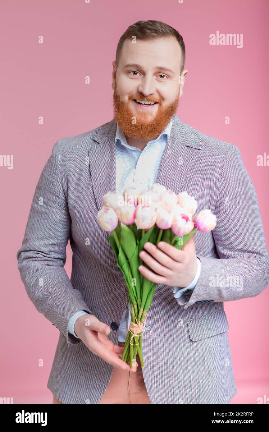 Handsome man holding bouquet of tulips Stock Photo - Alamy