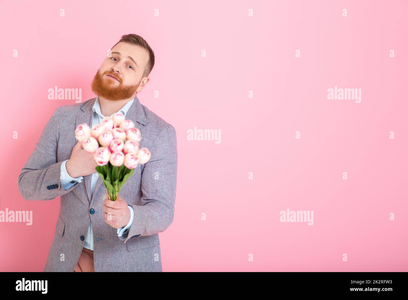 Handsome man holding bouquet of tulips Stock Photo - Alamy