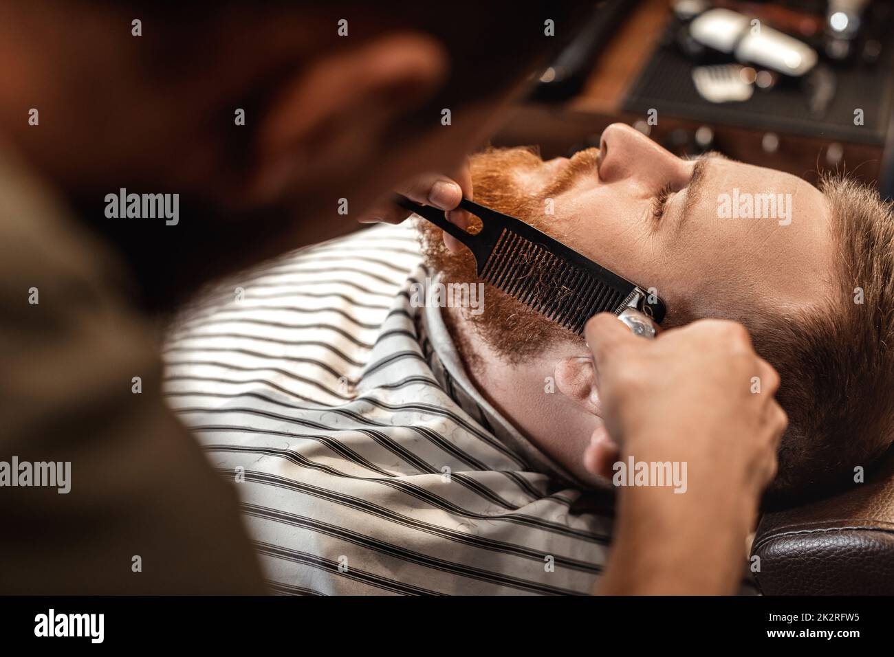 Barber and bearded man in barber shop Stock Photo - Alamy