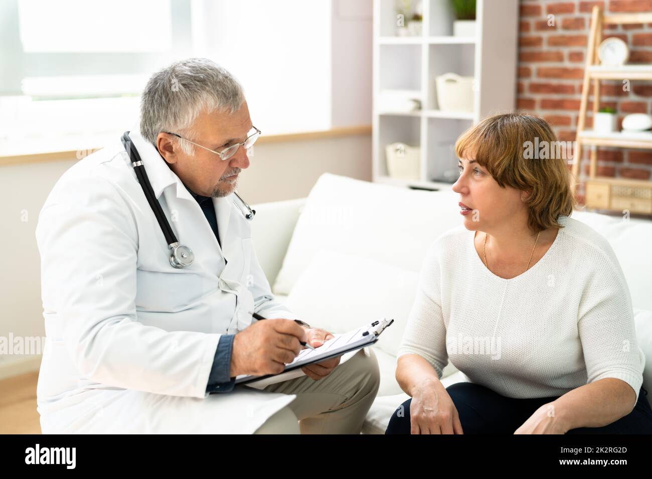 Doctor Talking With Elderly Patient Stock Photo - Alamy