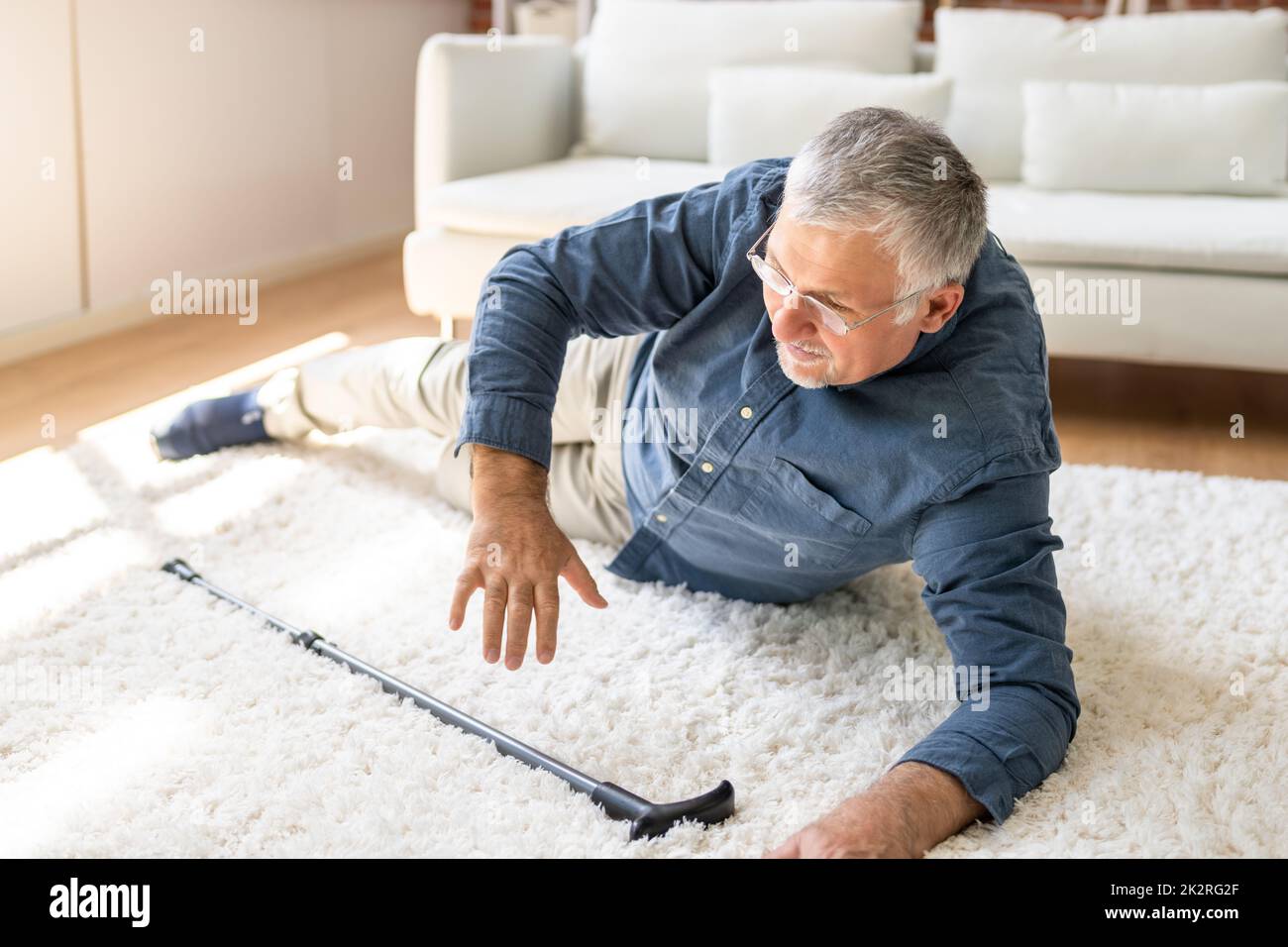 Senior Man Fallen On Carpet Stock Photo - Alamy