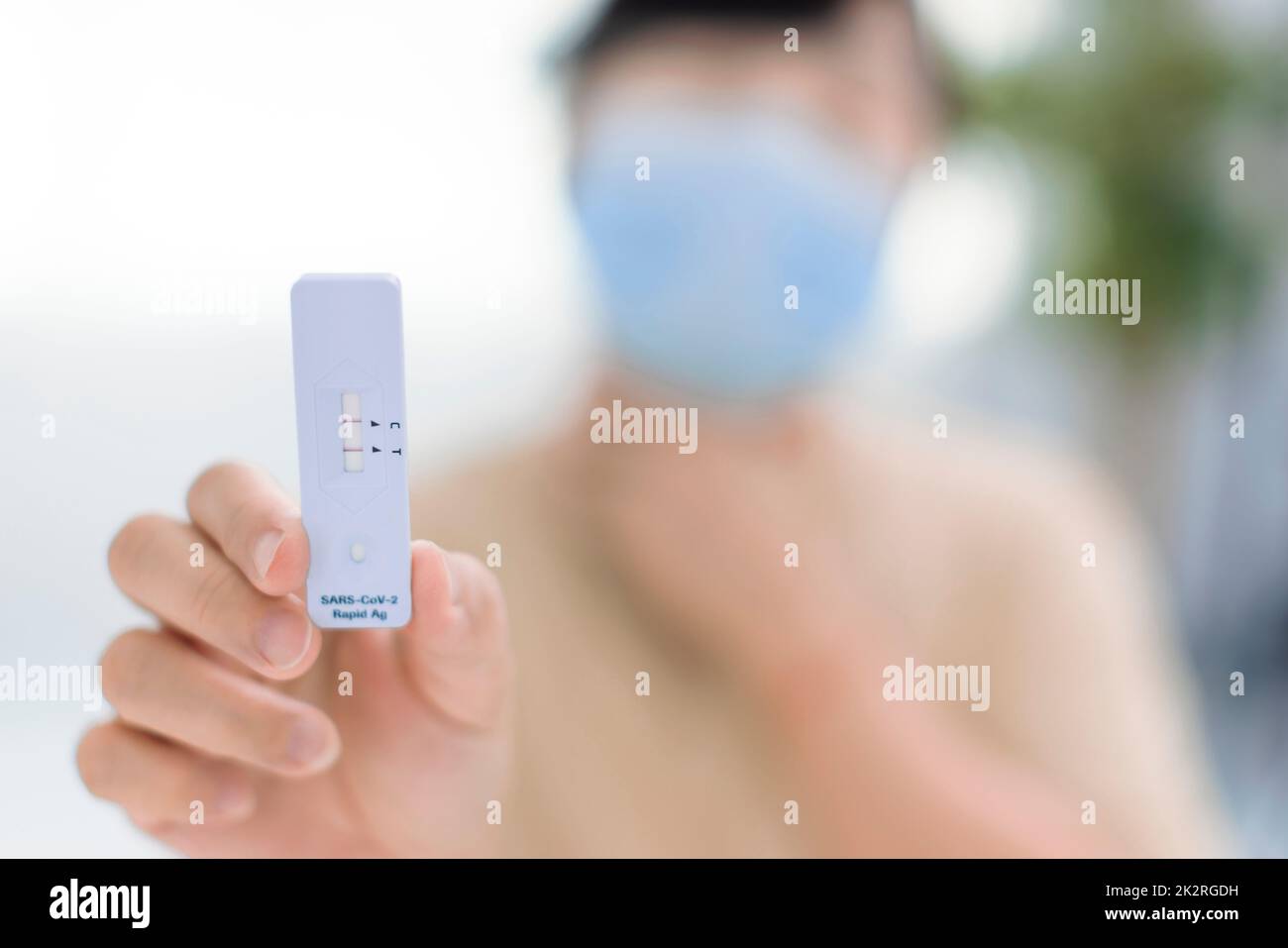 woman holding Rapid Antigen Test kit with Positive result during swab ...