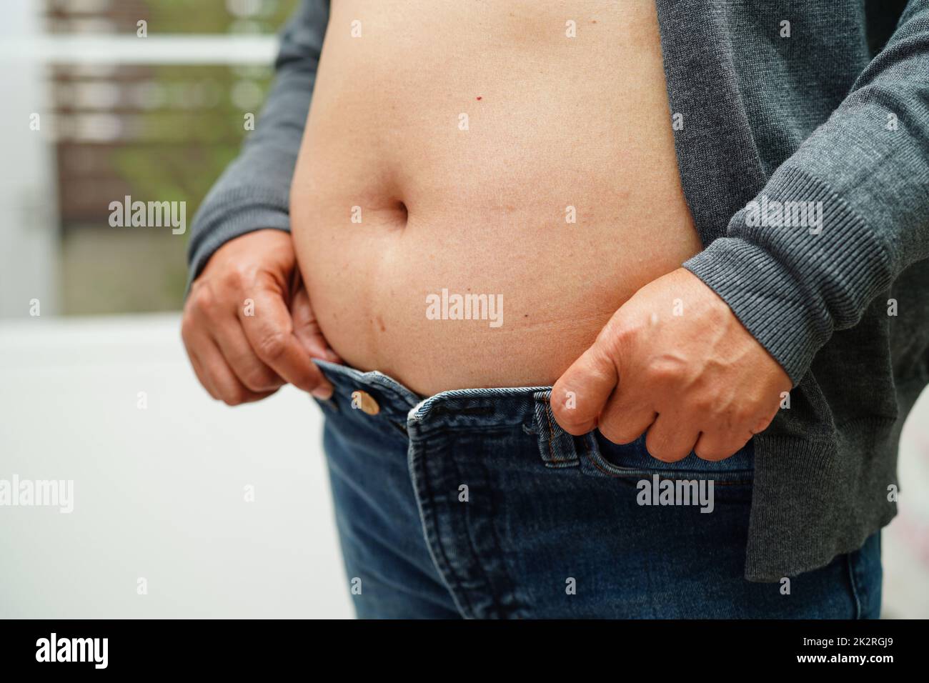 Asian woman show fat belly big size overweight and obesity at office ...