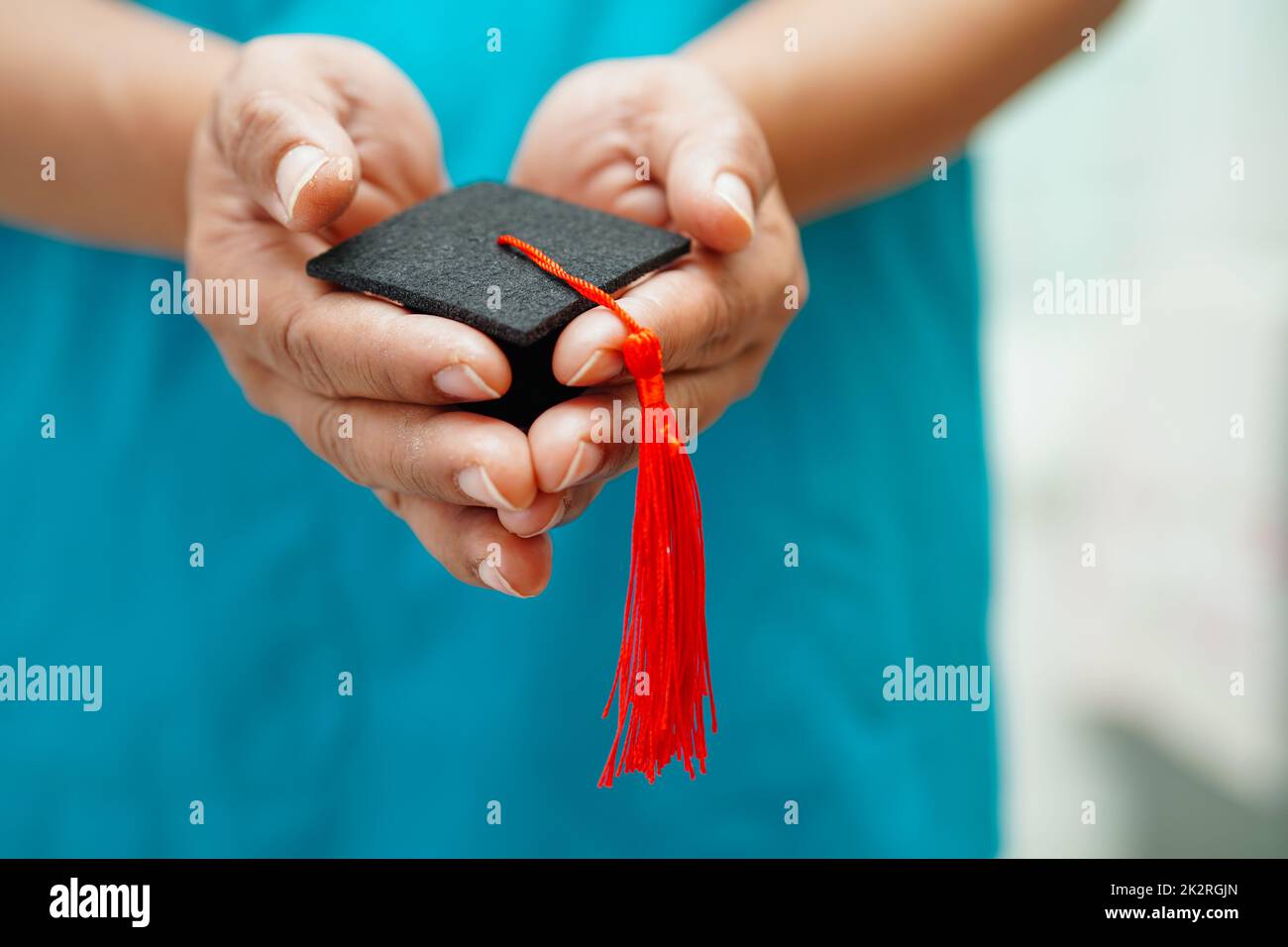 Asian woman doctor holding graduation hat in hospital, Medical ...