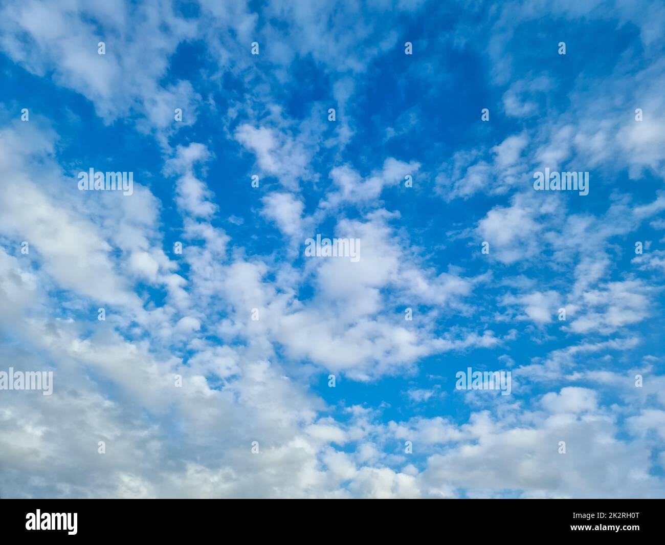 Beautiful fluffy white cloud formations in a deep blue summer sky Stock Photo - Alamy