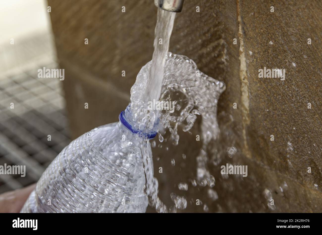 Filling water bottle Stock Photo - Alamy