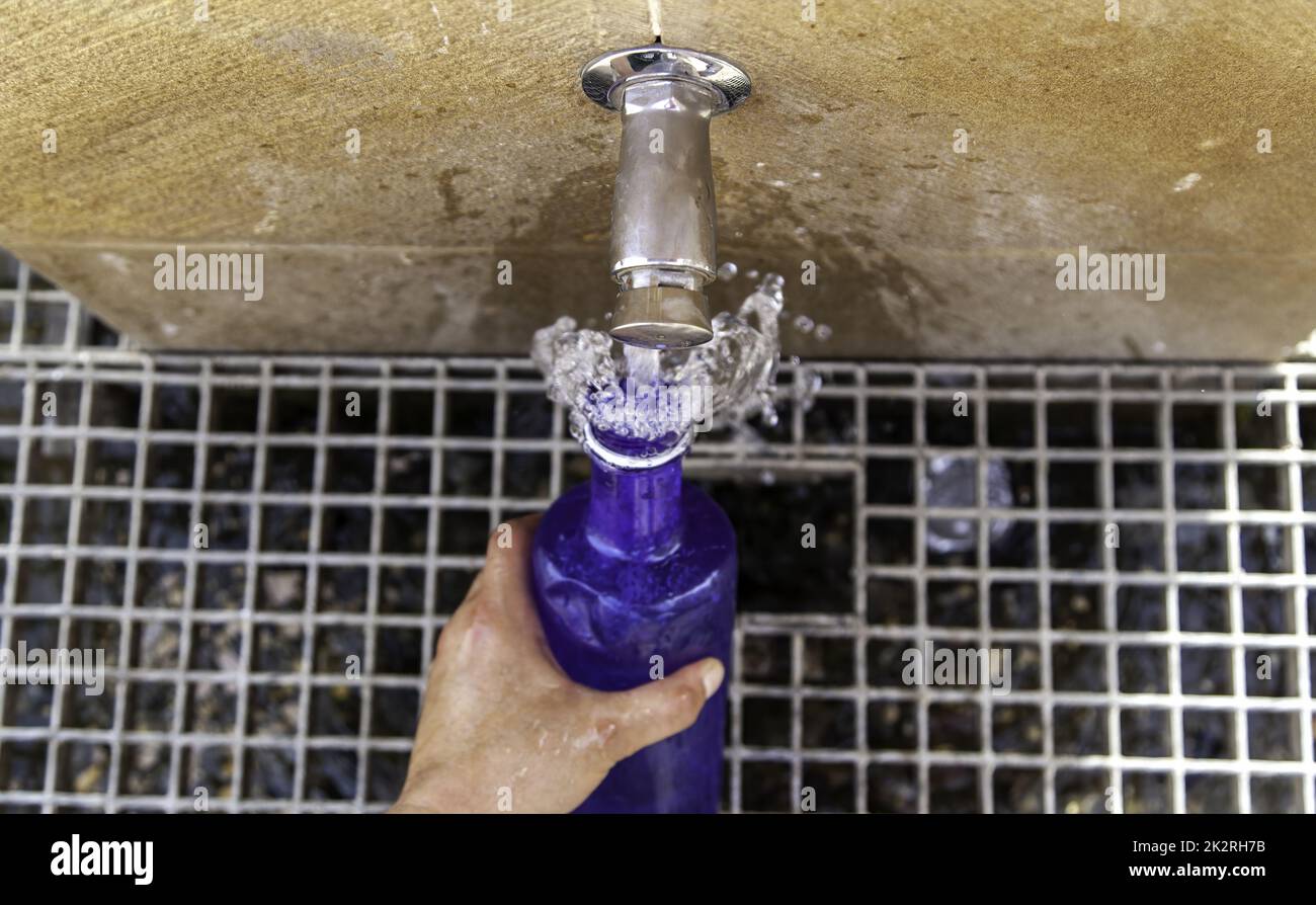 Filling water bottle Stock Photo - Alamy