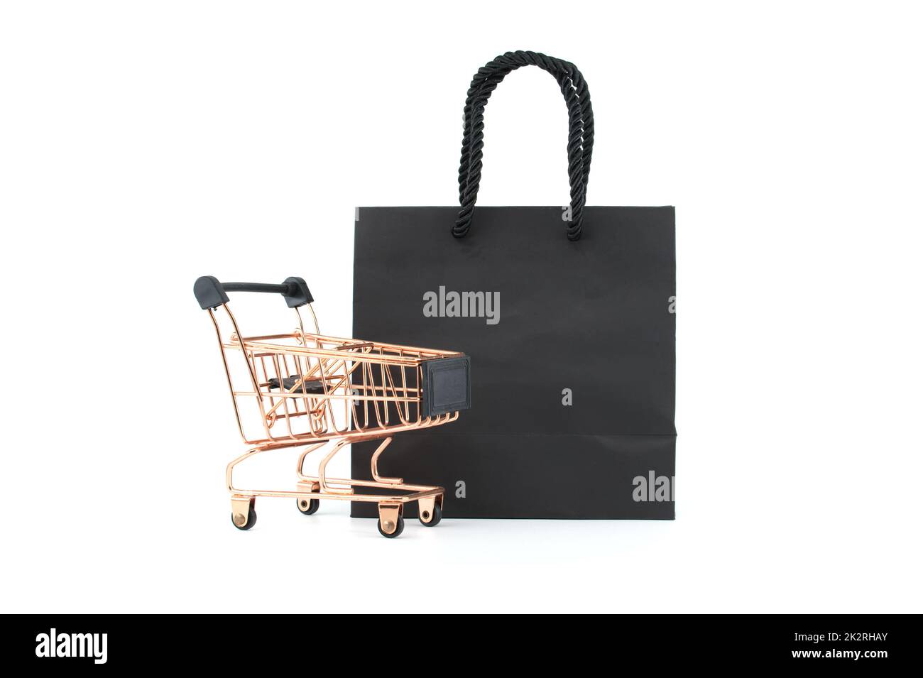 Shopping cart and black paper shopping bag on white Stock Photo - Alamy