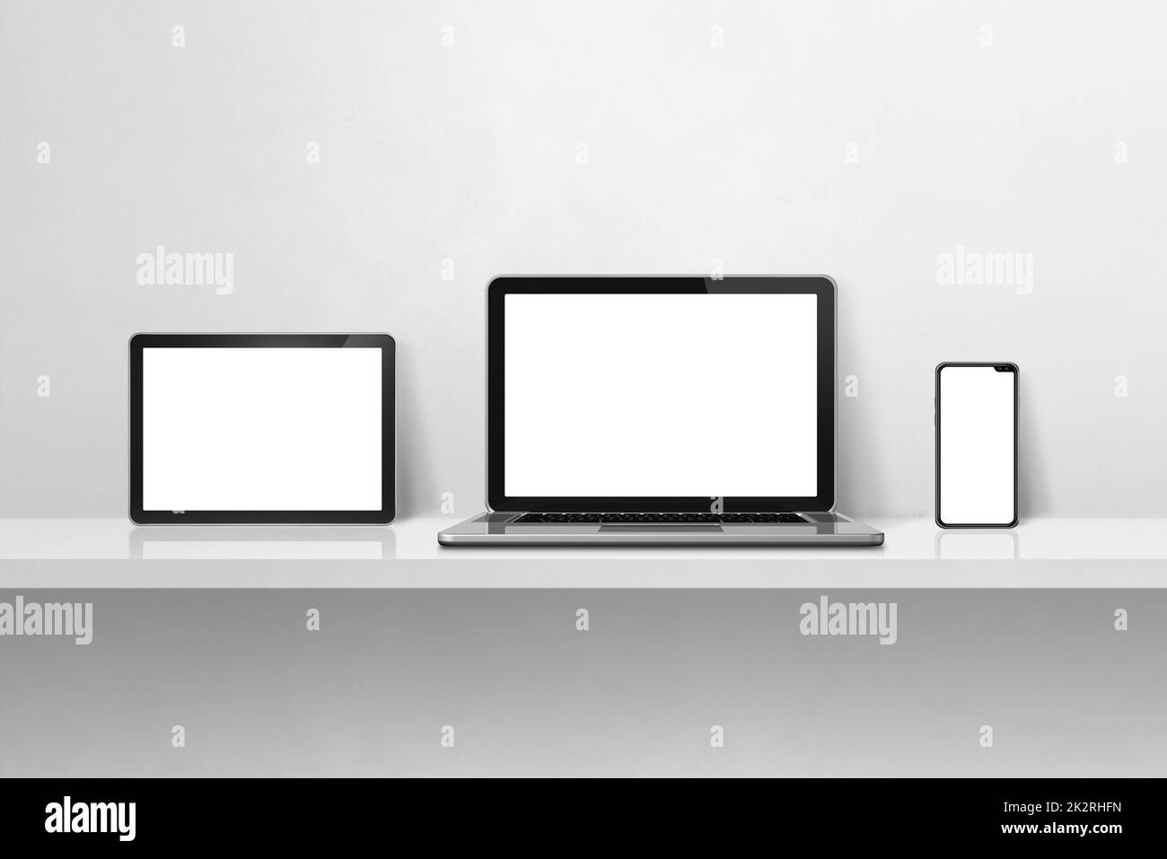 Laptop, mobile phone and digital tablet pc on white concrete wall shelf ...
