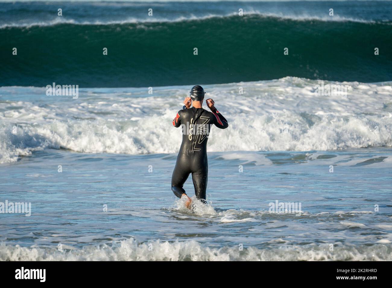 A young swimmer from behind at Bondi Beach heading out for a swim Stock ...