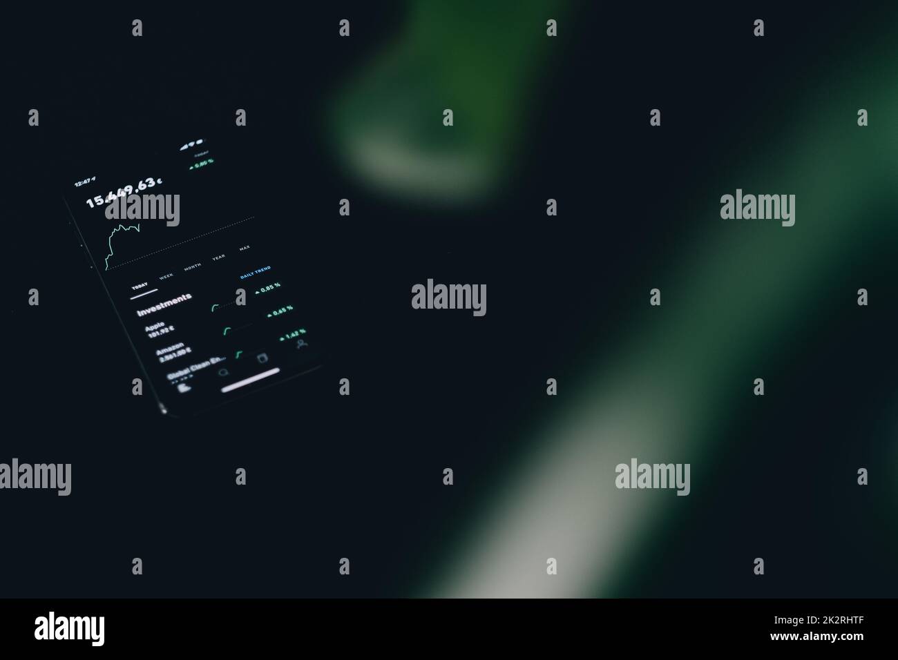 A black screen of a smartphone showing a stock market chart changes ...