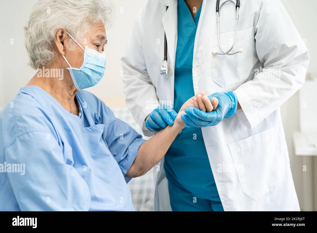 Doctor check Asian senior or elderly old lady woman patient wearing a ...