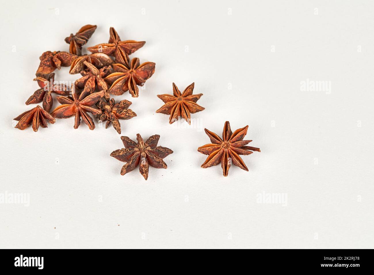 A handfull of Star Anise spices on a white background Stock Photo - Alamy