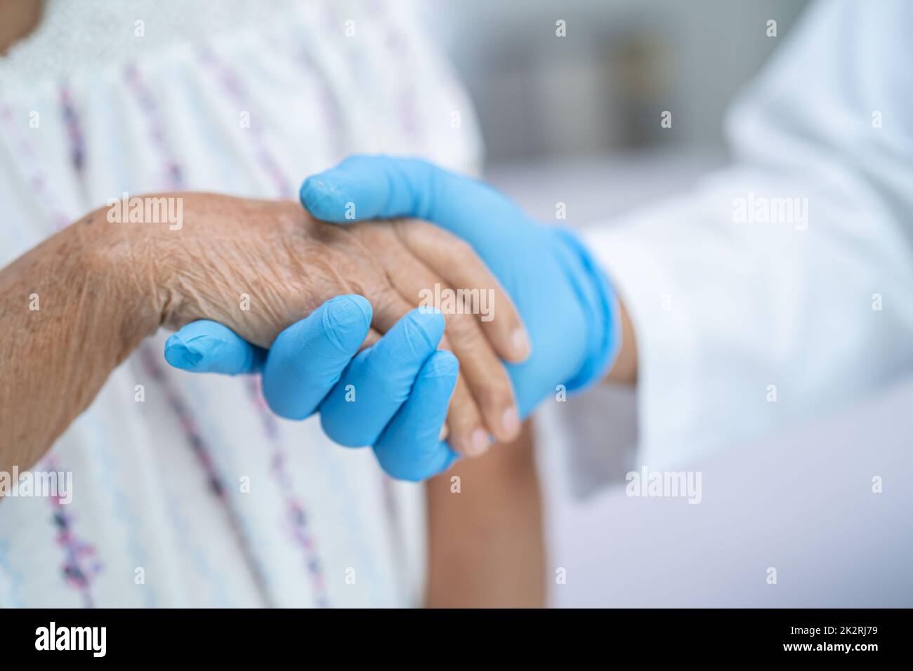Doctor holding touching hands Asian senior or elderly old lady woman ...