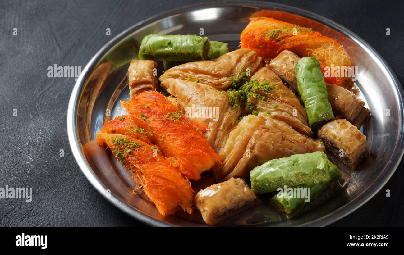 A tray of Turkish pastries including baklava, knafeh - a Middle Eastern ...