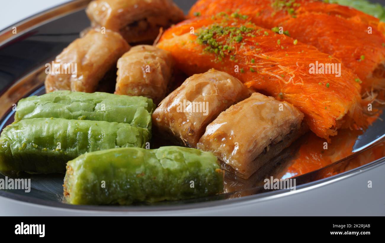 A tray of Turkish pastries including baklava, knafeh - a Middle Eastern ...