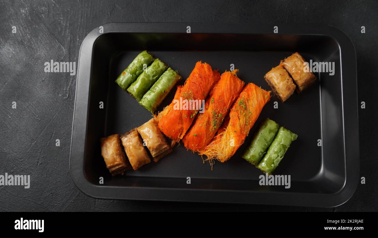 A tray of Turkish pastries including baklava, knafeh - a Middle Eastern ...