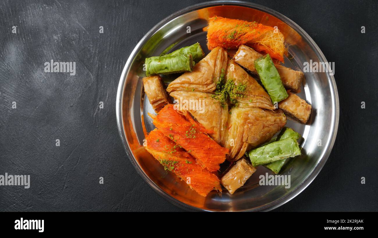 A tray of Turkish pastries including baklava, knafeh - a Middle Eastern ...