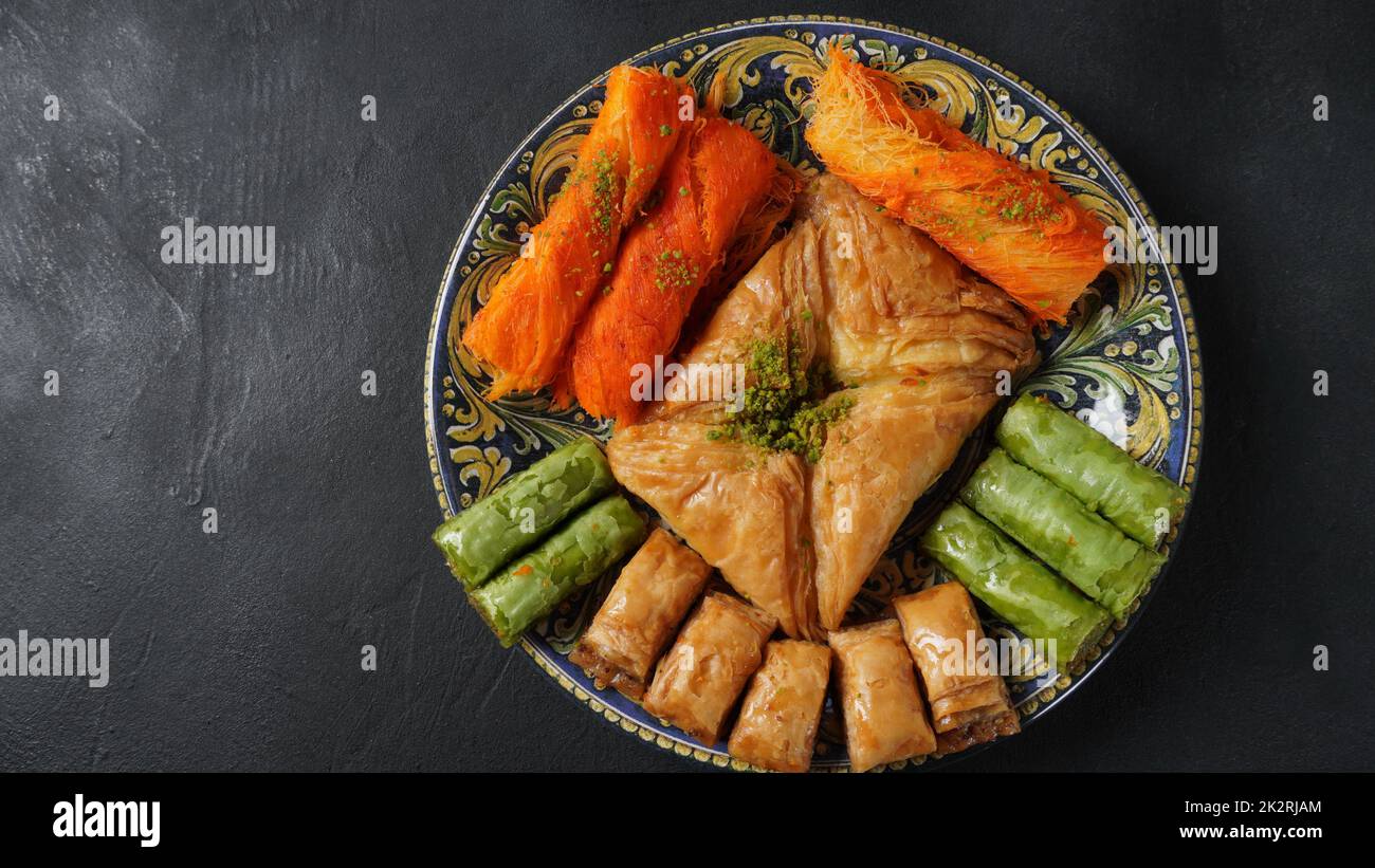 A tray of Turkish pastries including baklava, knafeh - a Middle Eastern ...