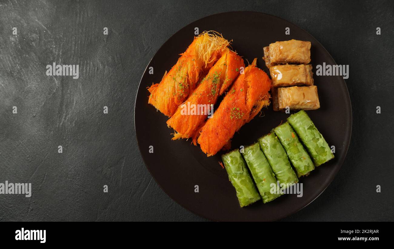 A tray of Turkish pastries including baklava, knafeh - a Middle Eastern ...
