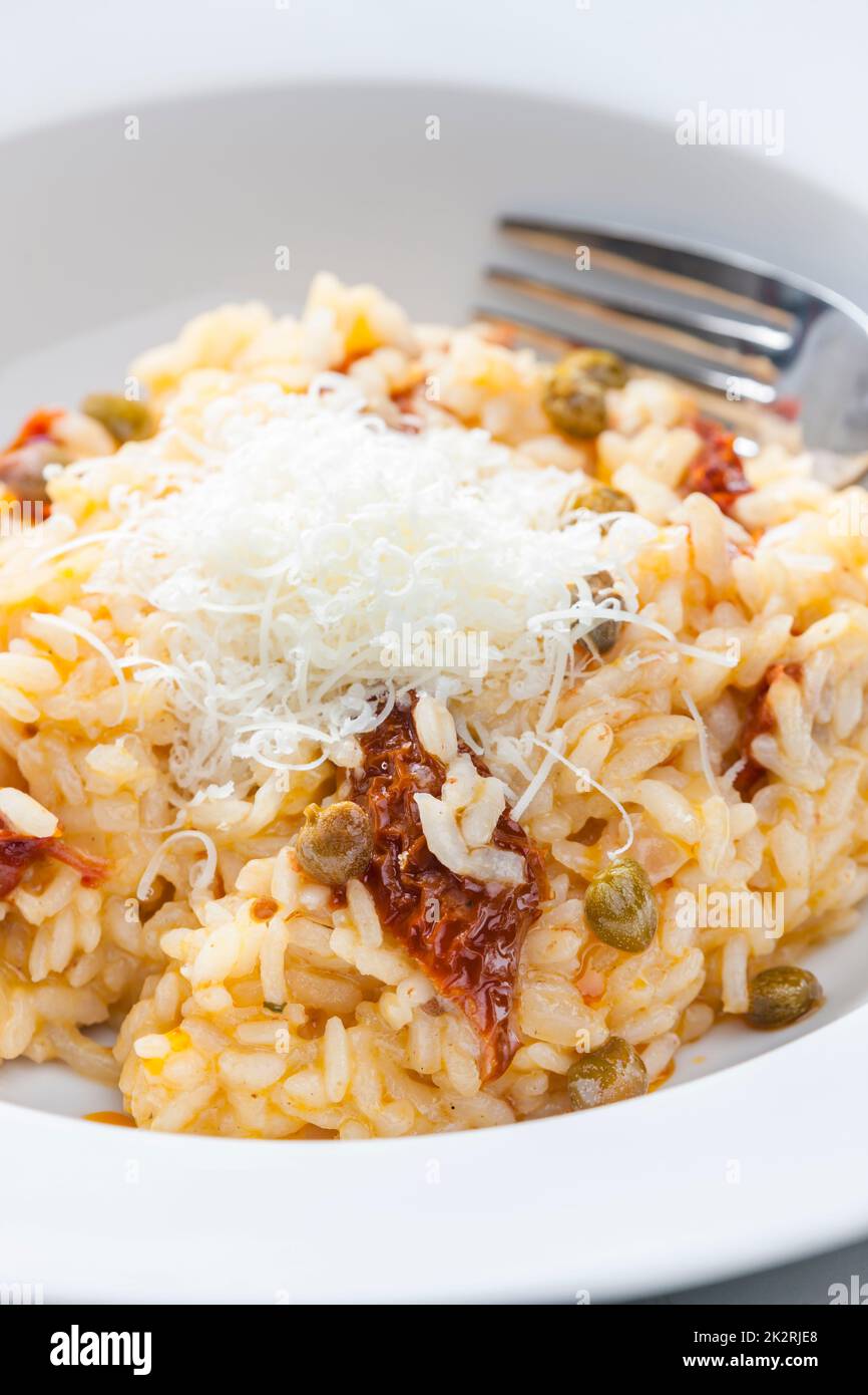 Italian risotto with dry tomatoes and capers Stock Photo - Alamy