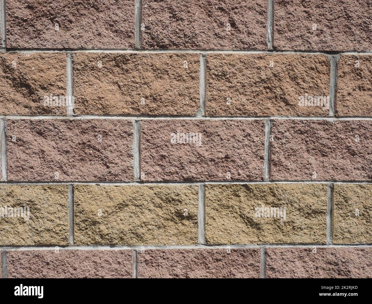 brown and yellow stone brick wall background Stock Photo - Alamy