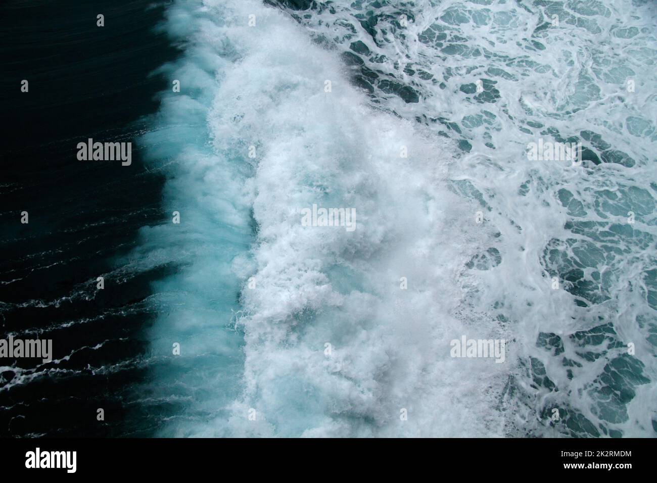 Aerial view to seething waves with foam. Blue water background ...